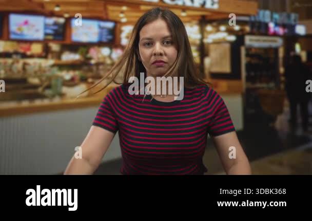Woman showing middle finger gesture with both hands toward camera in ...