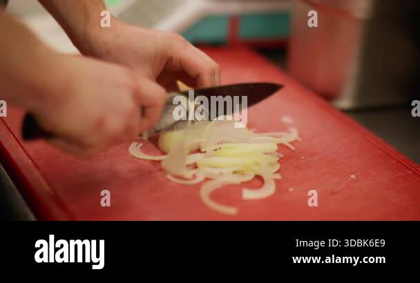 Chopping onion. Slicing vegetable. Chef hand professionally cutting raw ...