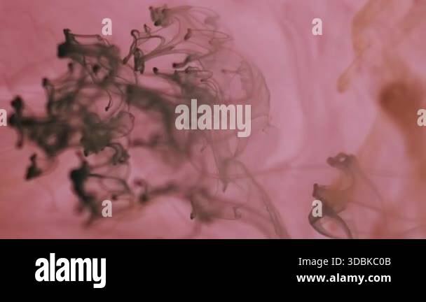 Floating color ink. Defocused flow. Peach brown gray dye spilling ...