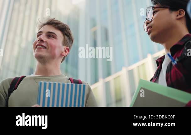 Two student friends talking in urban campus in the city after classes ...