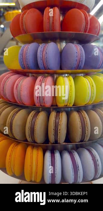 A beautiful tower of colorful macarons displayed in the showcase of a ...