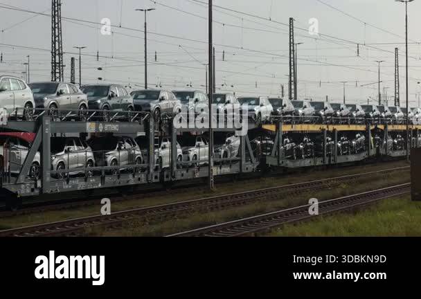 Freight train loaded with brand new cars transporting vehicles through ...