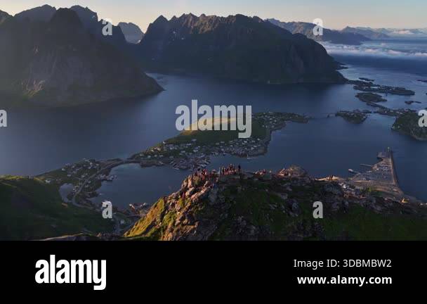Tourists gather on reinebringen mountain, enjoying the breathtaking ...