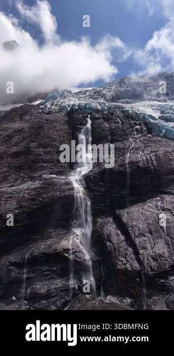 Stunning view of a glacial waterfall as meltwater cascades down a steep ...