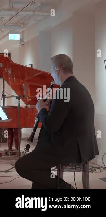 Male musician playing the clarinet during a classical music performance ...