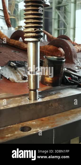 Precise alignment of heavy machinery components during an industrial assembly process Stock ...