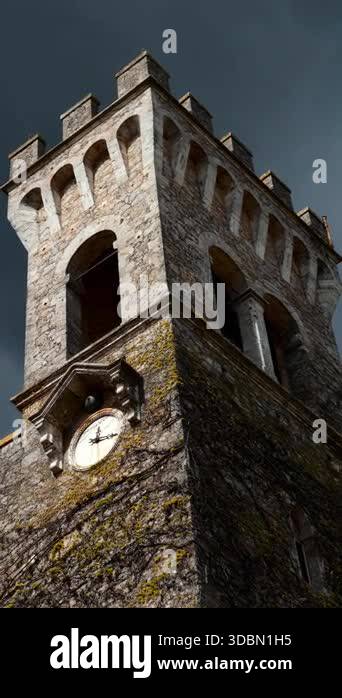 Majestic medieval tower clock rising against a dramatic, stormy sky ...