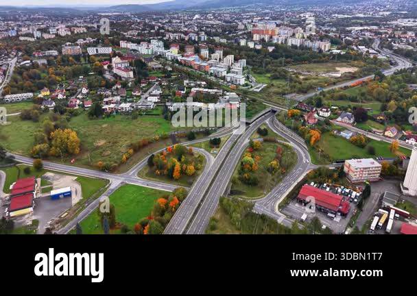 aerial highway interchange above suburban town, sweeping roads and ...
