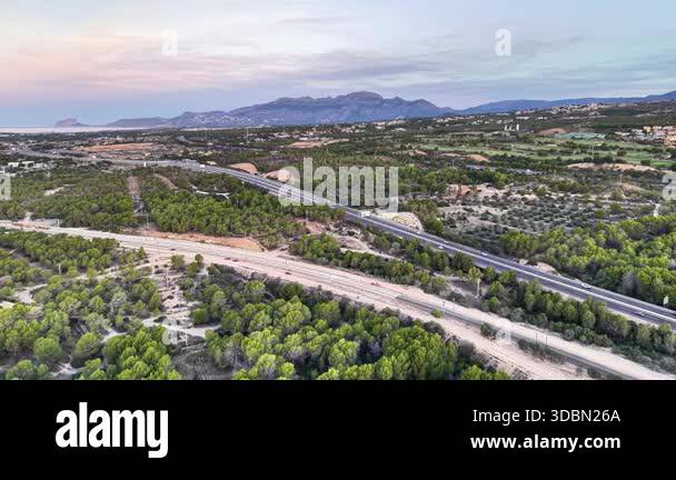 Dusk Aerial Highway Corridor With Trees And Distant Mountains, Soft ...