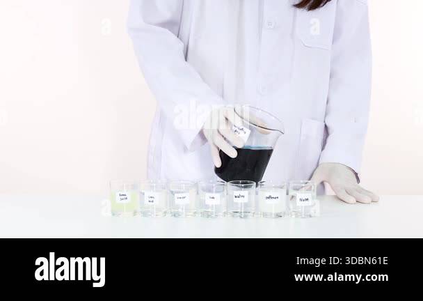 Pouring liquid to demonstrate pH indicator color change Stock Video ...