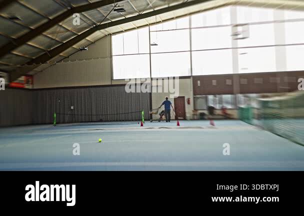 indoor tennis serve, male competitor demonstrates intense serve ...