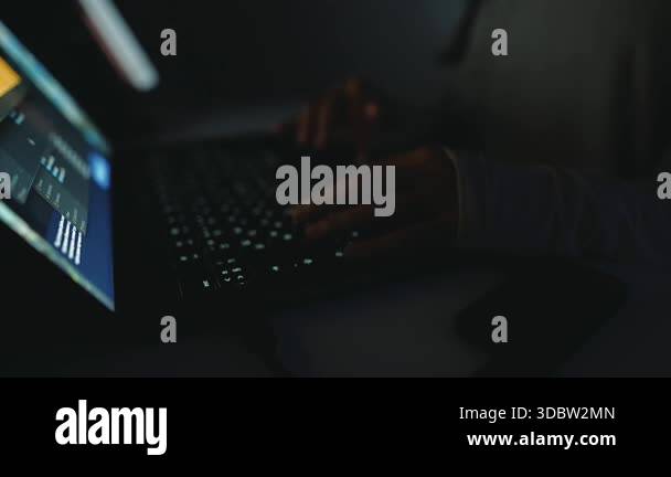 dark workstation with glowing laptop screen, hands typing code on backlit keyboard, focused ...