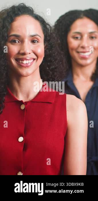 Portrait of two happy and confident business women smiling in a modern ...