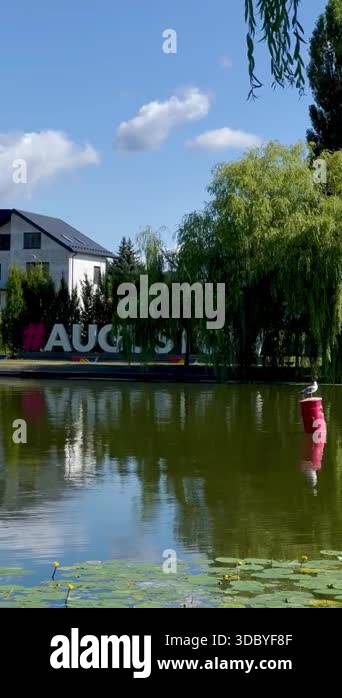 Calm waterway in Augustow, Poland, features reflective water with ...