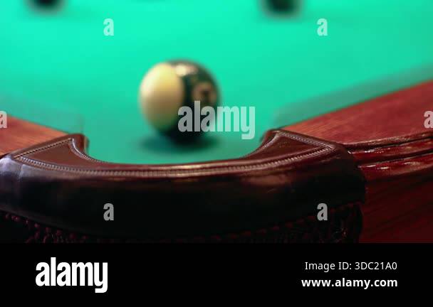Excitement builds as the pool ball balances on the edge of the table ...