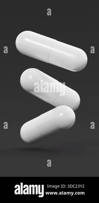 Animation of white medicine capsules rotating against black backdrop ...