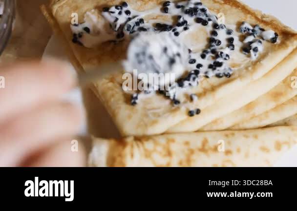 Spreading lump fish black roe with taramasalata on blinis Stock Video ...