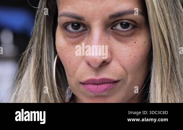 Blonde Woman Facing Camera With Intense Gaze And Neutral Face In Quiet ...