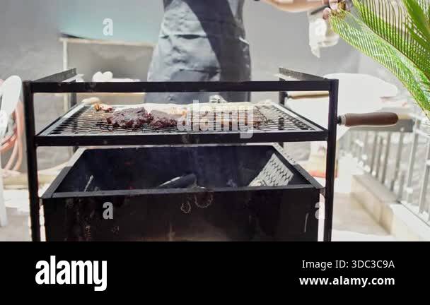 Person Cooking Steak On Barbecue Grill Using Fork And Knife To Turn ...