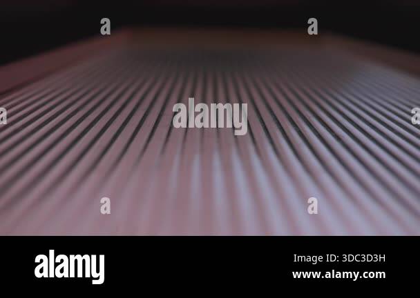 A close view of a ribbed surface forms repeating lines that draw into ...