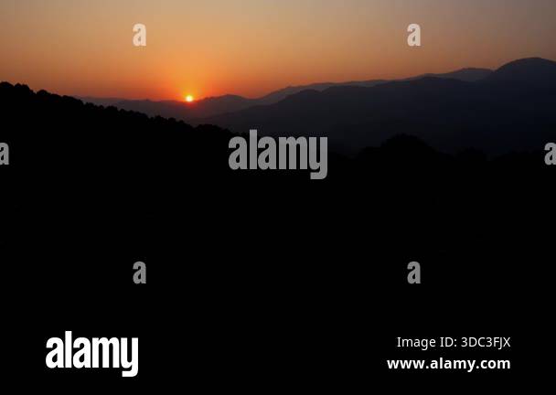 Sunset glow behind himalayan mountains. A stunning winter sunset lights ...