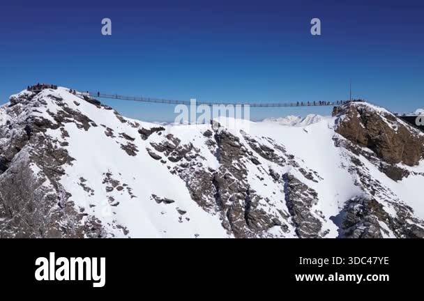 People Walking Across the Suspension Bridge on Glacier 3000 with Cable ...