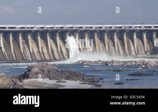 A hydraulic dam blocks the river channel among rocks and rapids Stock ...
