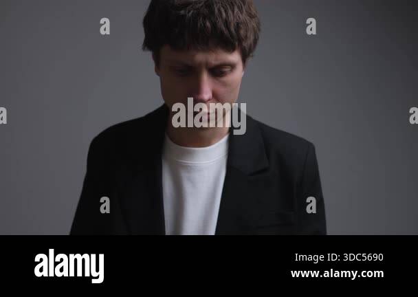 Silent sadness, man looking down with subtle emotional pain and ...