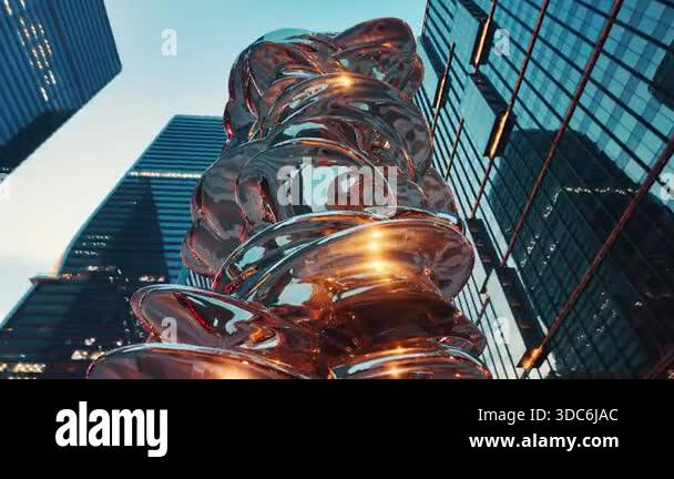 modern metallic shiny sculpture in downtown district of big city, urban ...