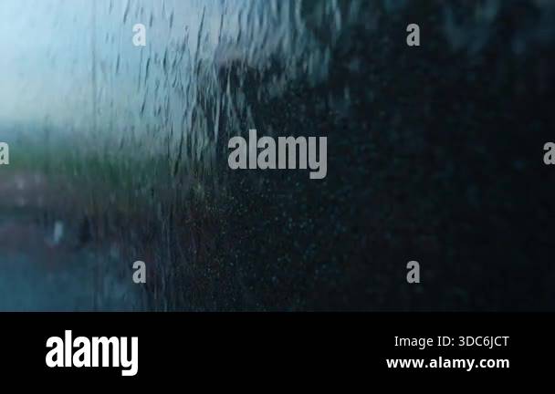 slow motion of water flowing down from modern wall, streams dripping on ...