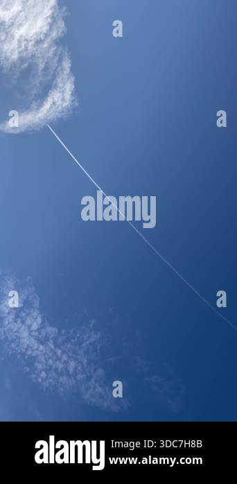 High Altitude Contrail in Blue Sky. Long, white vapor trail (contrail ...