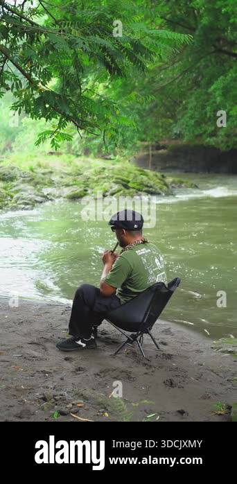 A male musician plays a wind instrument called a tin whistle against ...