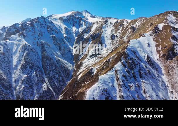 Aerial drone footage captures majestic snow-covered mountains in ...