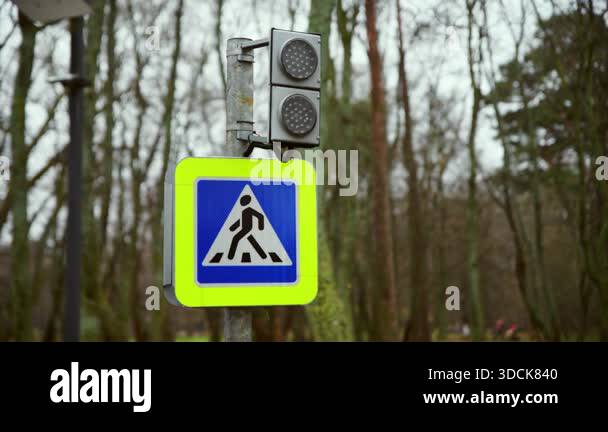 Red pedestrian traffic light signals stop next to brightly colored ...