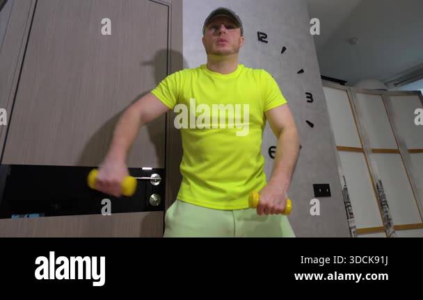 Train dumbbell shoulder joint hands on training at home. Men's workout ...