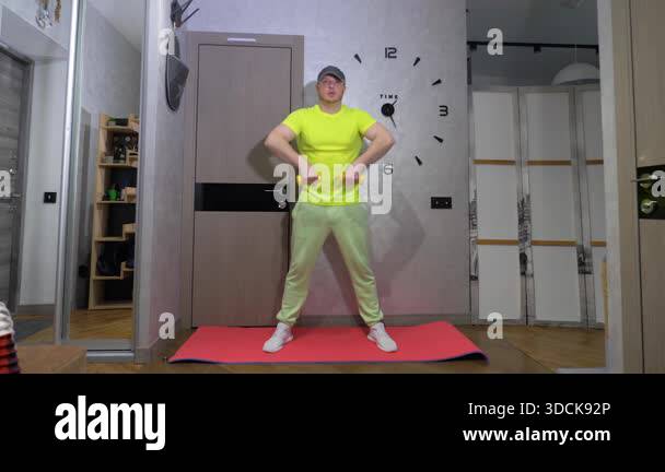 Train dumbbell shoulder joint on training at home. Men's workout a on a ...