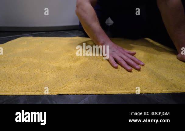 Stroking a shaggy rug with your hand. A man runs his hand over a rug in ...