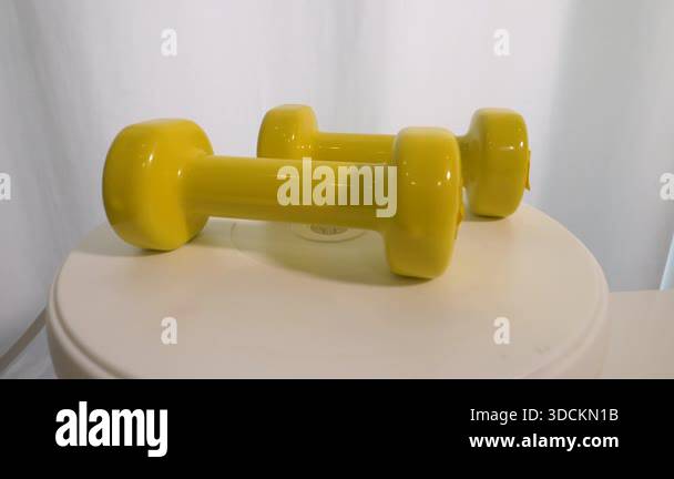 Vinyl dumbbell yellow 1 kg weight, on a rotary table, sports dumbbell ...