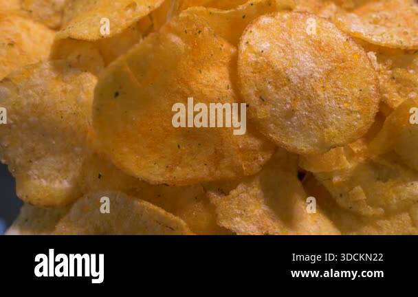 Top view macro. Potato chips in a plate spinning in motion. Fried ...
