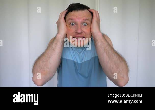 The man shows emotions of fear and surprise. Facial expressions imitate ...