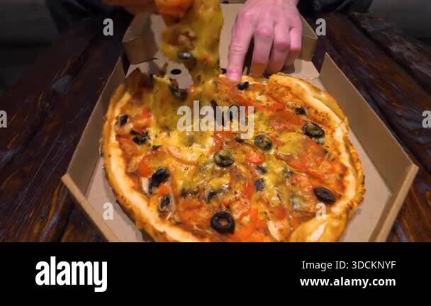 Man eats pizza from a cardboard box, eat fast food with cheese and ...