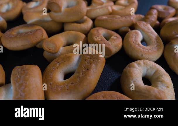 Fried Rusks rings, baking bagels on black table, spinning on turntable ...