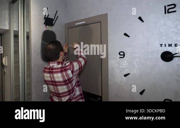 A master handyman measures a door with a tape measure and a ...