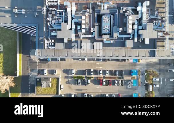 Aerial view of modern office building rooftops transitioning to parking ...