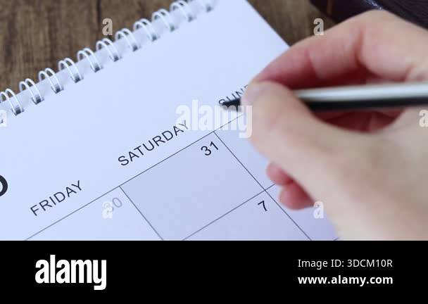 Close up of hand holding pen and marking Saturday (Christian Sabbath ...