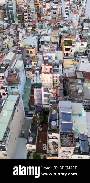 Drone aerial view of dense residential housing and rooftops in Ho Chi ...