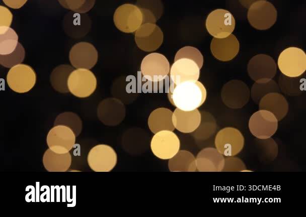 Flashing yellow Christmas lights and bokeh from the blur. Dark ...