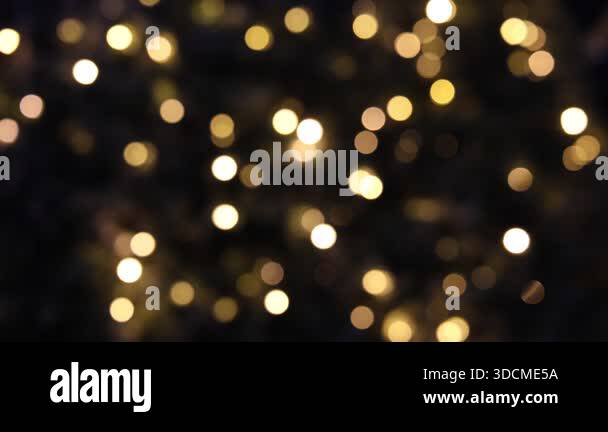 Flashing yellow Christmas lights and bokeh from the blur. Dark ...