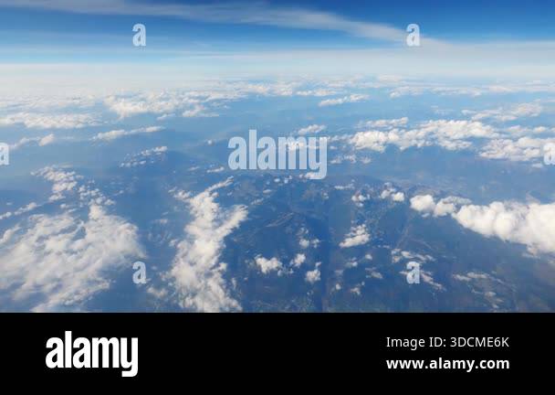 Top view of mountainous terrain from airplane window during flight ...