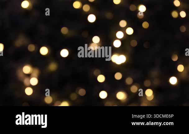 Flashing yellow Christmas lights and bokeh from the blur. Dark ...